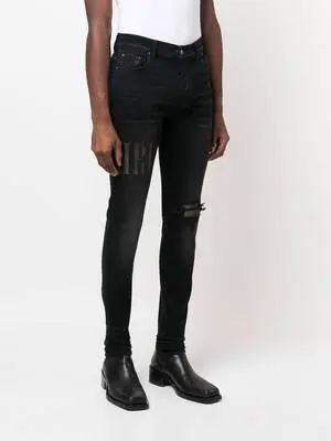 Amiri Logo-appliqué Distressed Jeans