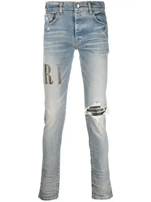 Amiri Logo-print Distressed Skinny Jeans - Blue