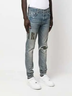 Amiri Logo-print Distressed Skinny Jeans - Blue