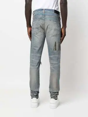 Amiri Logo-print Distressed Skinny Jeans - Blue