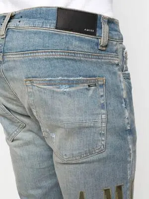 Amiri Logo-print Distressed Skinny Jeans - Blue