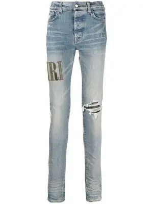 Amiri Logo-embroidered Ripped-detail Jeans - Blue