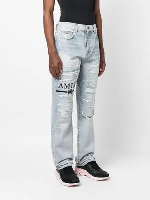 Amiri Logo-embroidered Ripped Jeans