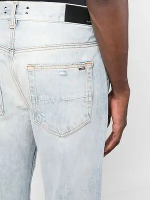 Amiri Logo-embroidered Ripped Jeans