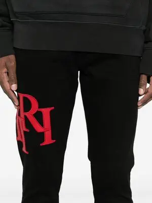 Amiri Staggered-logo Jeans