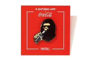 A BATHING APE X Coca Cola Ape Head Pintrill Pin - Brown