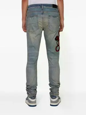Amiri Appliqué Distressed Skinny Jeans