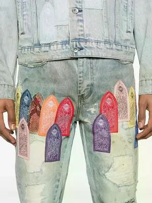 WHO DECIDES WAR Patch Arched Distressed Jeans