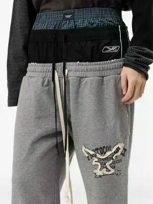 PROTOCOL INDEX Layered Eagle-patch Track Pants
