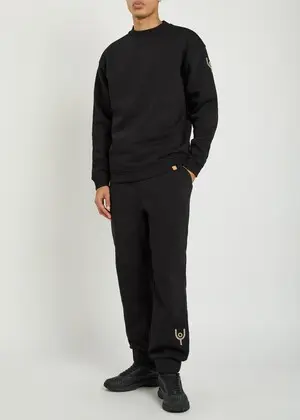 NOW YOU LIVE Magna Logo-embroidered Cotton-blend Sweatpants - Black