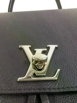 LOUIS VUITTON Lock Me Evergrain Leather Backpack