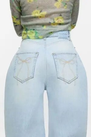 Acne Studios Light Wash Denim Trousers With Embroidered Bows