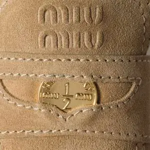 Miu Miu Embossed Logo Slip-on Mules - Beige