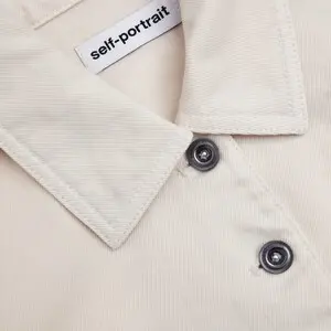 SELF-PORTRAIT Logo-embossed Cropped Jacket - Cream