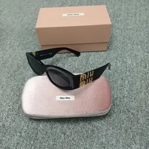 Miu Miu Cat Eye Sunglasses With Logo Detail - Black/gray