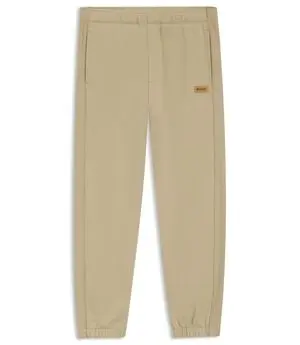 Hugo Cotton-terry Sweatpants With Logo Badge - Beige