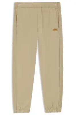 Hugo Cotton-terry Sweatpants With Logo Badge - Beige