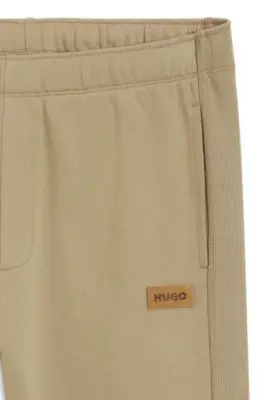 Hugo Cotton-terry Sweatpants With Logo Badge - Beige