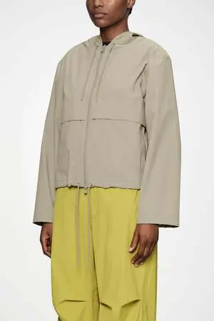 Rains Suva Hardshell Cropped Jacket With Drawstring Hood And Zip Pockets - Beige