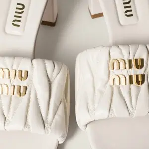 Miu Miu Matelassé Nappa Leather Slides With Gold Lettering Logo - White