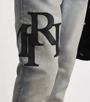 Amiri Staggered Logo Skinny Jeans