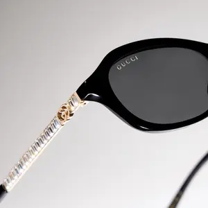 Gucci Oval Frame Sunglasses With Crystal Embellishments