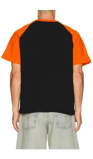 PLEASURES Trophy Raglan Tee