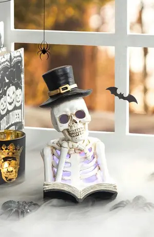 GLITZHOME 10.25"h Halloween Lighted Resin Skull Reading Book Table Decor
