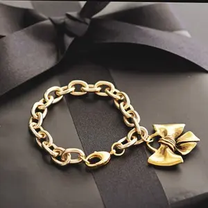 BOWOOD LANE 12k Plated Oval Link Chain Bow Charm Bracelet