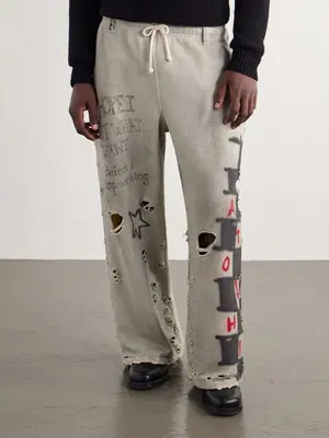SATOSHI NAKAMOTO Get What I Want Printed Embellished Distressed Cotton-jersey Sweatpants