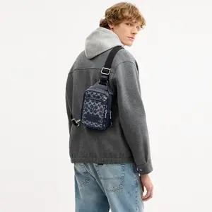 COACH OUTLET Racer Sling Pack In Signature Canvas With Charms