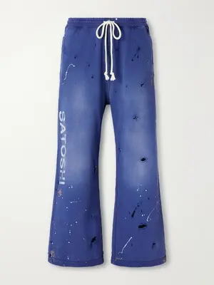 SATOSHI NAKAMOTO Luke Logo-printed Paint-splattered Distressed Cotton-jersey Drawstring Sweatpants - Blue