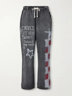 SATOSHI NAKAMOTO Get What I Want Distressed Embellished Printed Sweatpants - Black