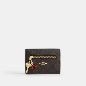 COACH OUTLET Card Case With Charms In Signature Canvas - Gold/walnut/black