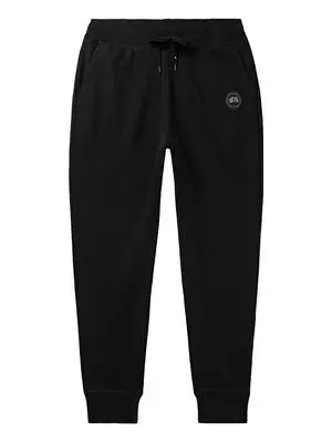 Canada Goose Label Huron Tapered Logo-appliquéd Cotton-jersey Sweatpants - Black