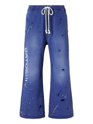 SATOSHI NAKAMOTO Luke Logo-printed Paint-splattered Distressed Cotton-jersey Drawstring Sweatpants - Blue