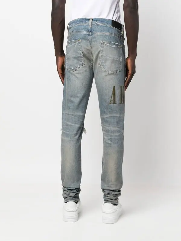 Amiri Logo-print Distressed Skinny Jeans - Blue