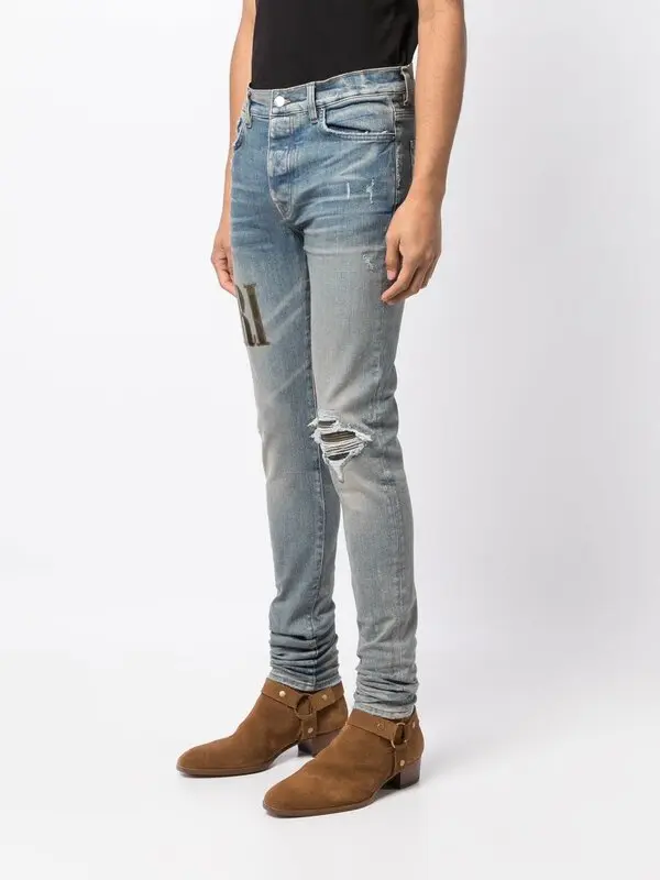 Amiri Logo-embroidered Ripped-detail Jeans