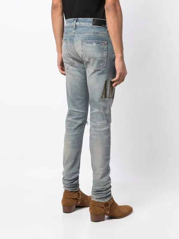 Amiri Logo-embroidered Ripped-detail Jeans