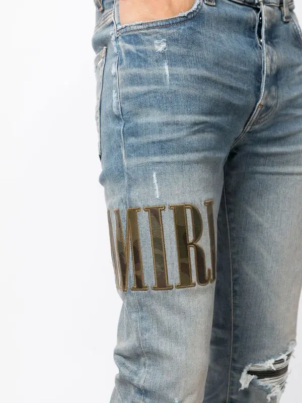 Amiri Logo-embroidered Ripped-detail Jeans
