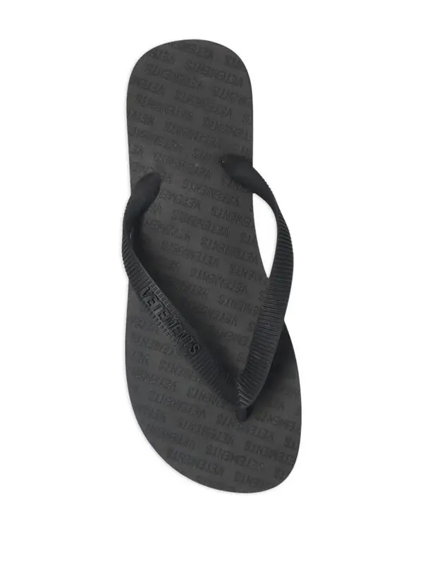 Vetements Embossed Logo Flip Flops In Black - 50% Off | Editorialist
