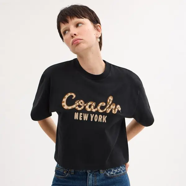 COACH Tシャツ ロゴT新品タグ付き Coach Snake Script Cropped T-Shirt - Black | Editorialist