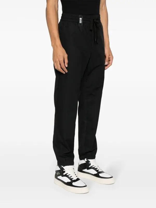 Versace Tapered-leg Trousers With Logo Strap