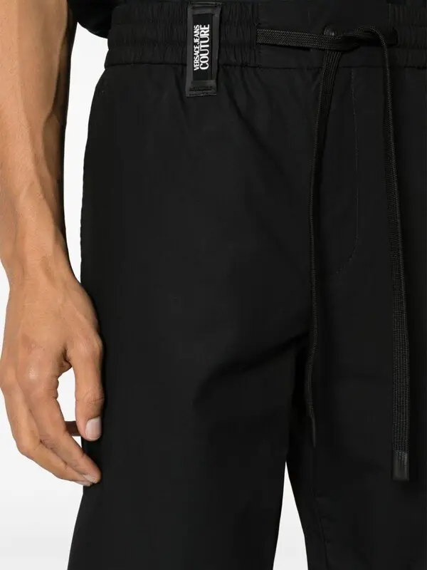 Versace Tapered-leg Trousers With Logo Strap