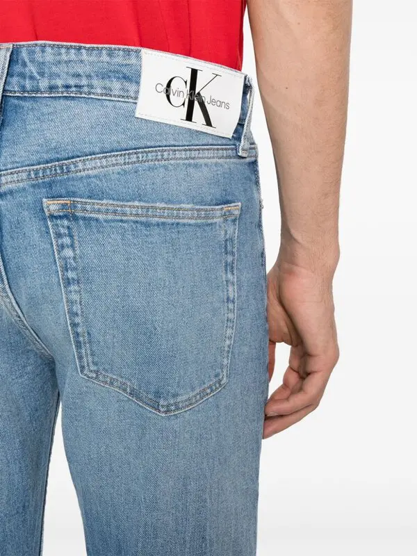 Calvin Klein Distressed Tapered-leg Jeans