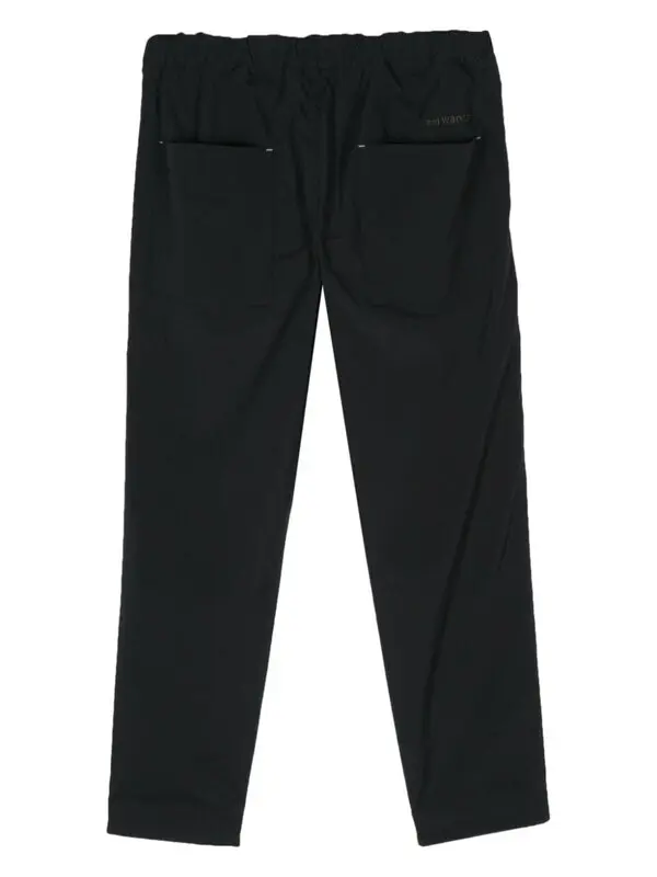 AND WANDER Belted Tapered-leg Trousers - Black
