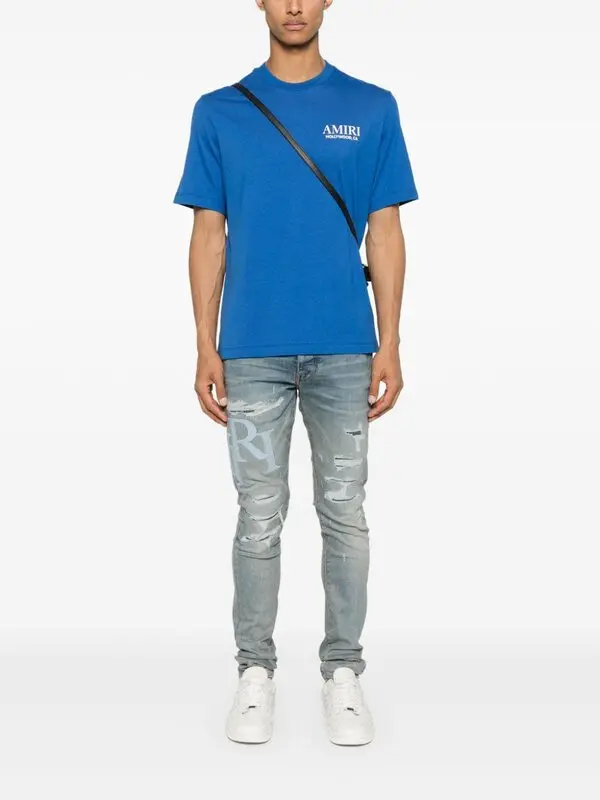 デニム・ジーパン Amiri STAGGERED LOGO SKINNY JEANS 23795993_54105373_322.jpg