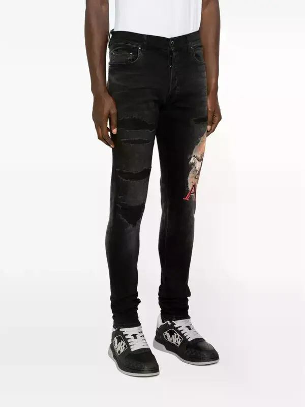 Amiri Ripped Graphic Jeans