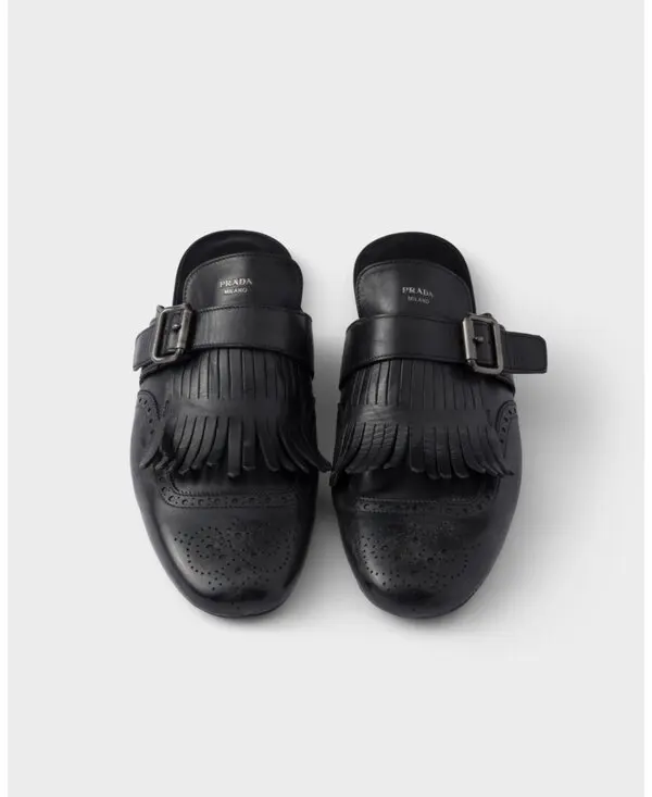 Prada Antiqued Leather Mules With Buckled Strap And Fringe - Black