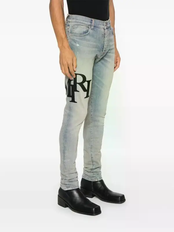 Amiri Skinny Jeans With Staggered Logo Embroidery